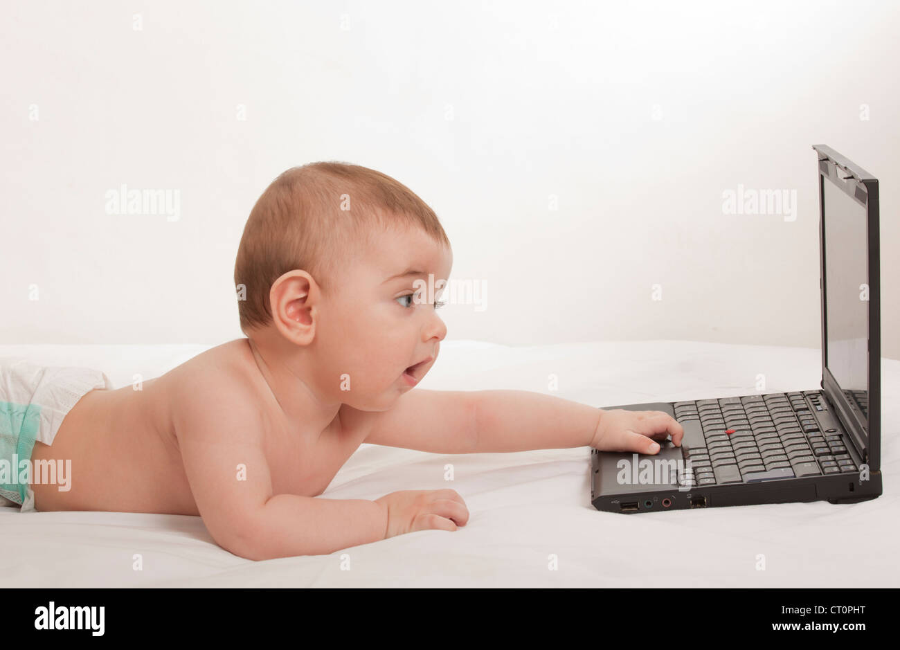 Baby with laptop on the white background Stock Photo - Alamy