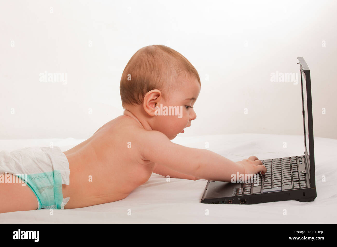 Baby with laptop on the white background Stock Photo - Alamy