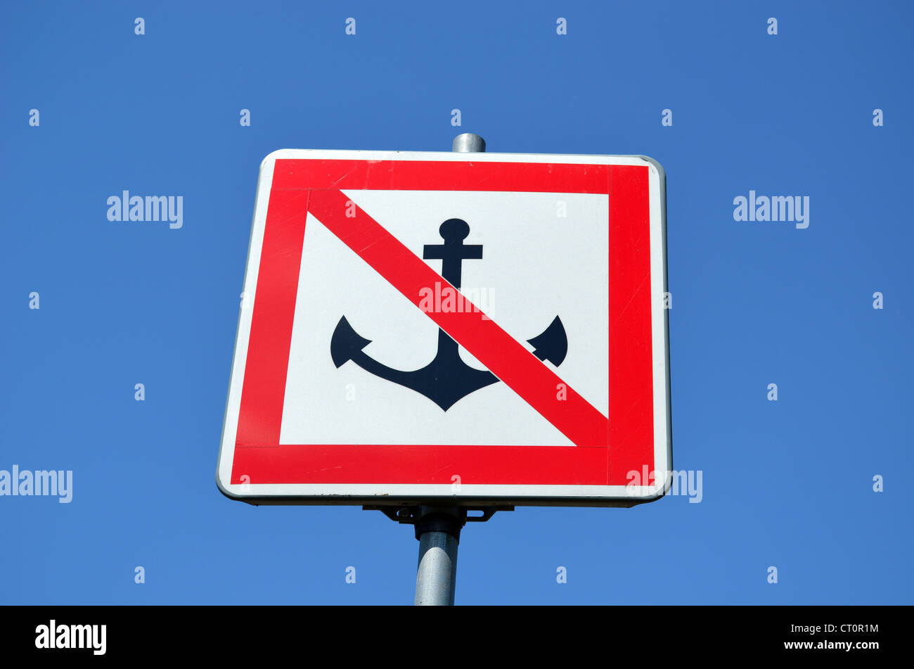 Warning sign prohibiting ships mooring riverside on background of blue ...