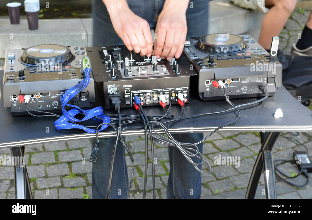 Dj hands play mix track turntable panel in outdoor street music day ...