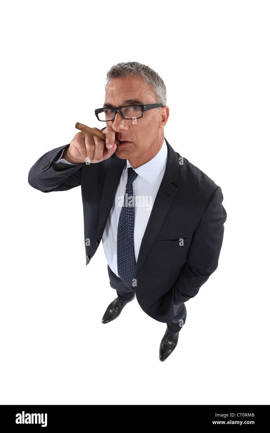 Businessman smoking cigar Cut Out Stock Images & Pictures - Alamy