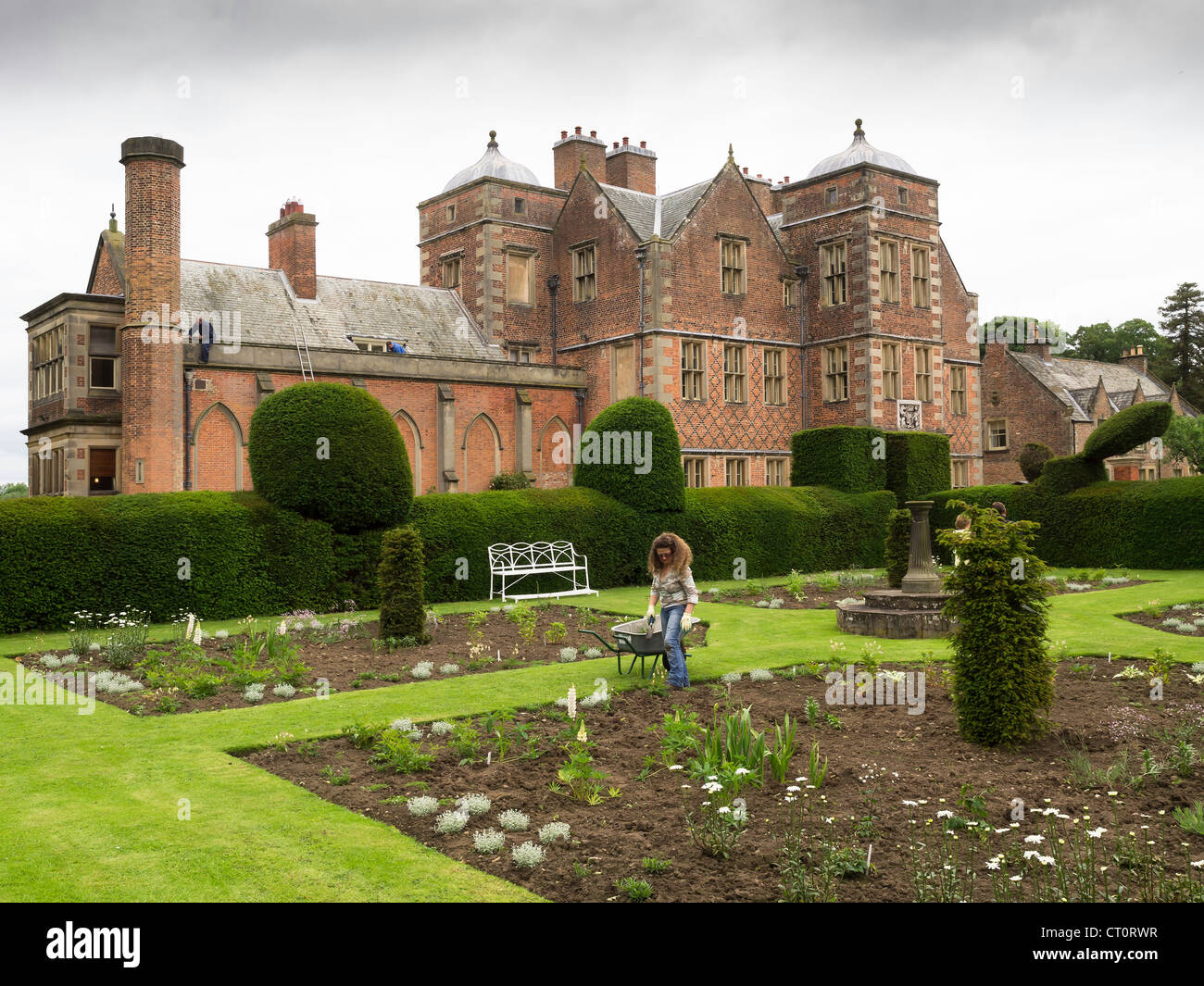 A gardener at work in the Topiary Garden at Kiplin Hall near Scorton ...