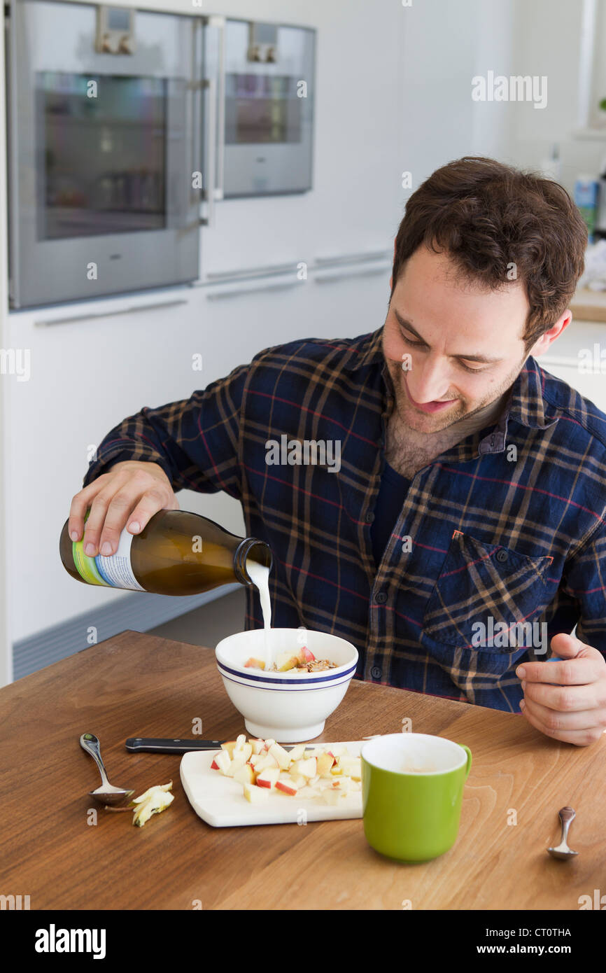 Man pouring milk for cereal Stock Photo - Alamy