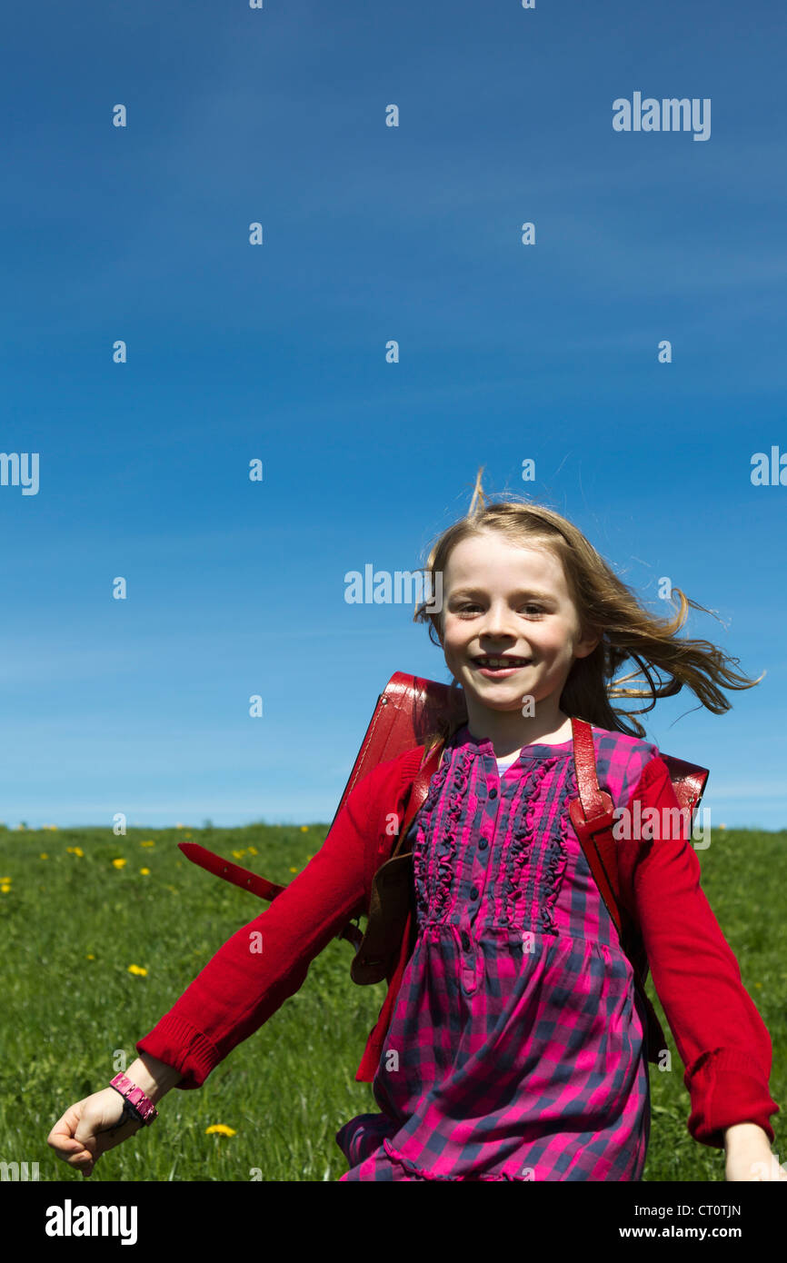 Smiling girl wearing backpack outdoors Stock Photo - Alamy