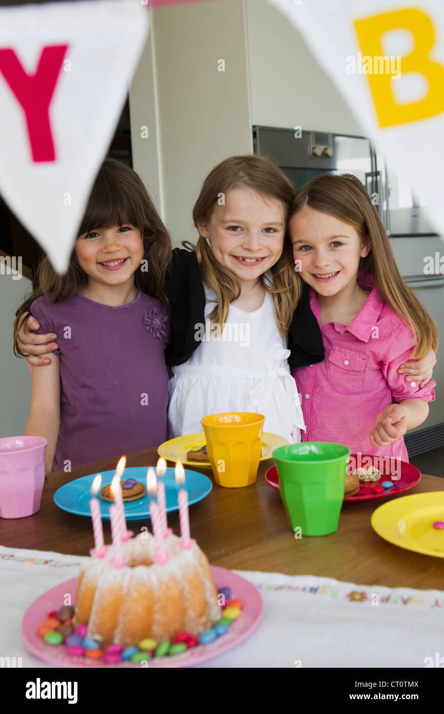 Smiling girls hugging at birthday party Stock Photo - Alamy