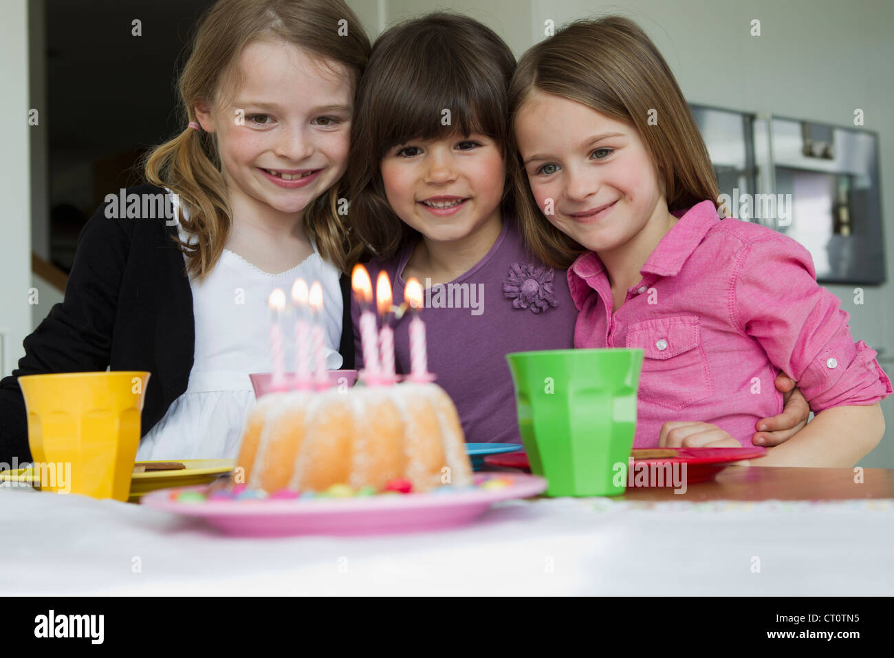 Smiling girls hugging at birthday party Stock Photo - Alamy