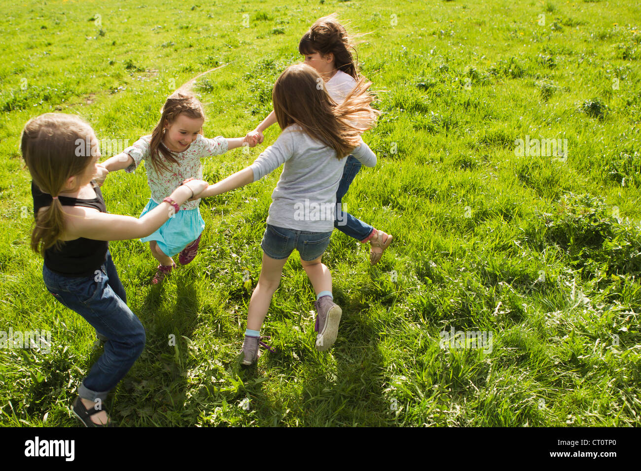 Girls playing in circle outdoors Stock Photo - Alamy