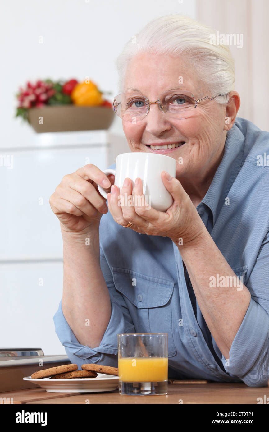 Elderly lady enjoying cup of tea Stock Photo - Alamy