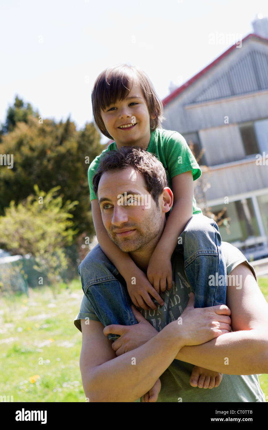 Father carrying son on shoulders Stock Photo - Alamy
