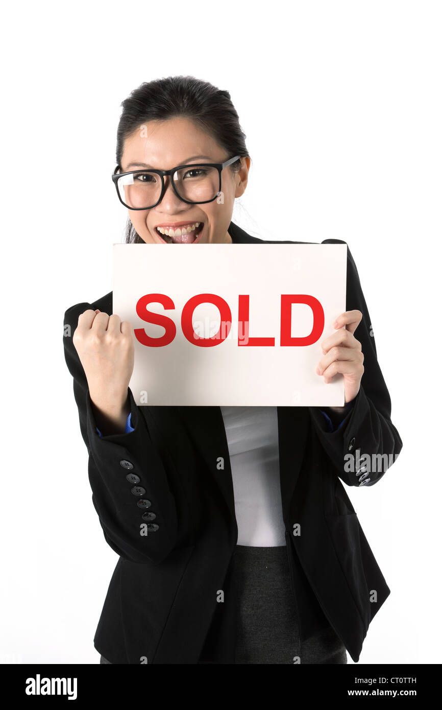 Female realtor holding sold sign hi-res stock photography and images ...