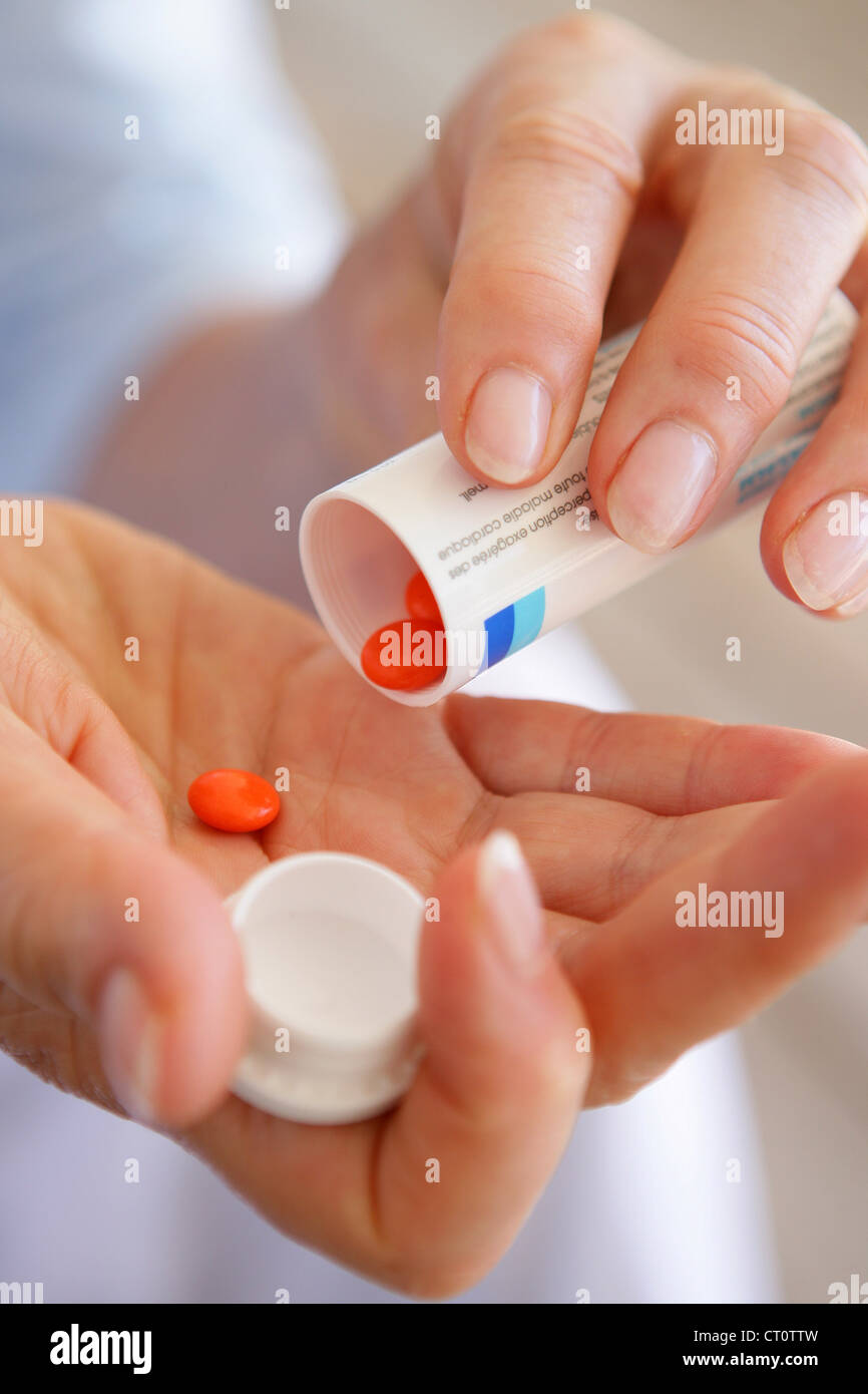 Woman taking medicine Stock Photo - Alamy