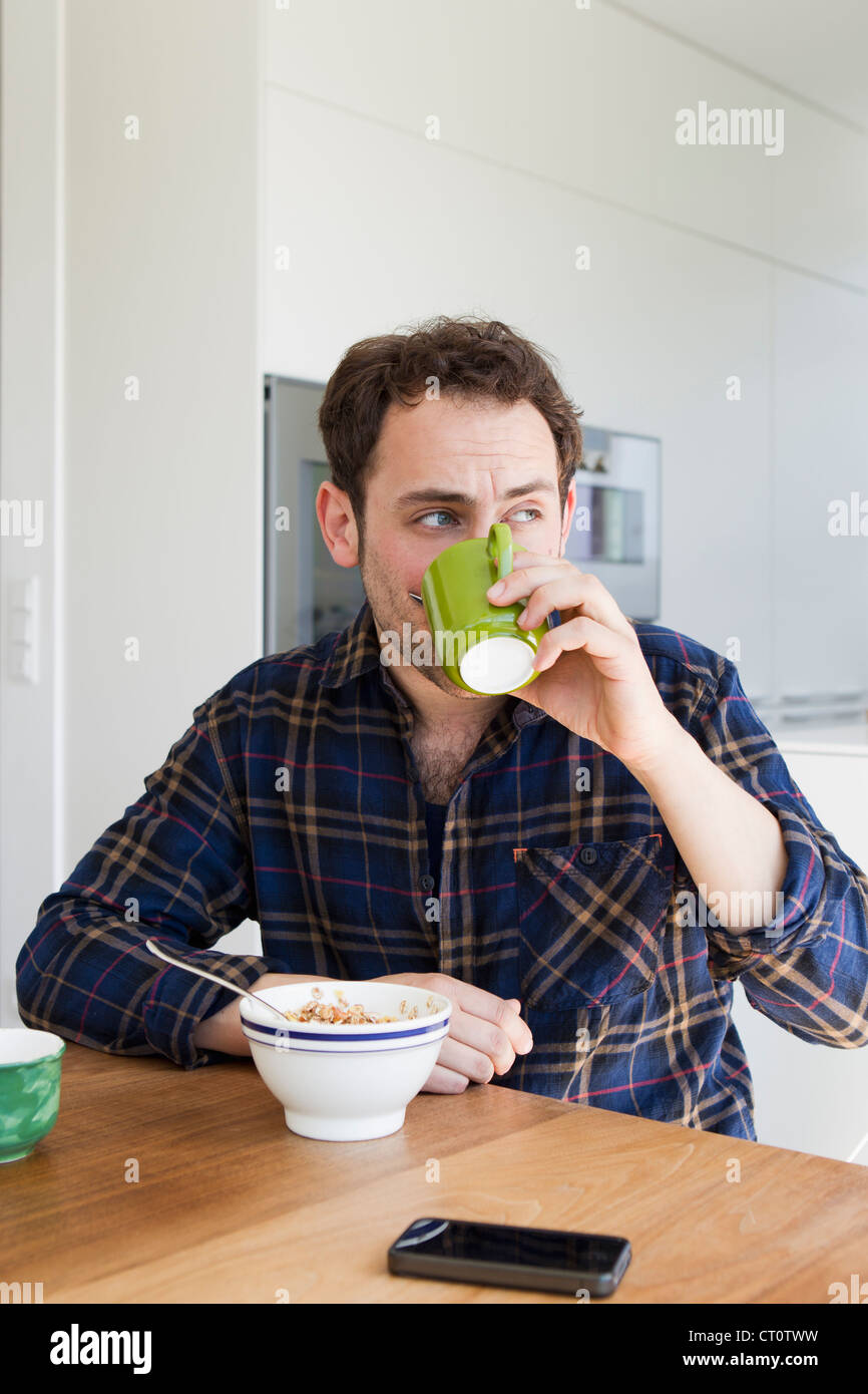 Man having breakfast at table Stock Photo - Alamy