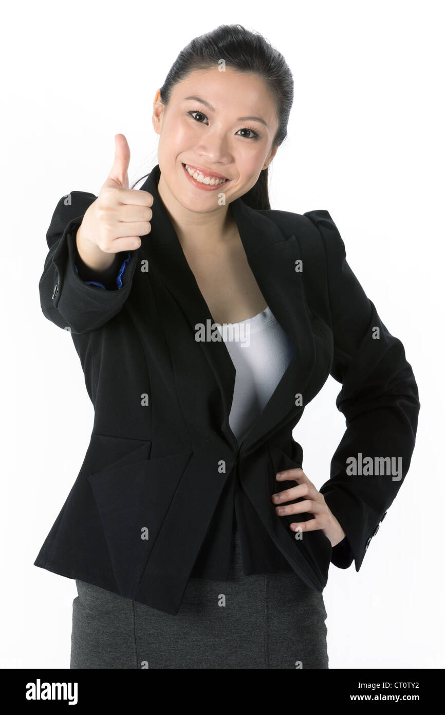 Portrait of happy Asian woman with her thumb pointing up. Isolated on a ...