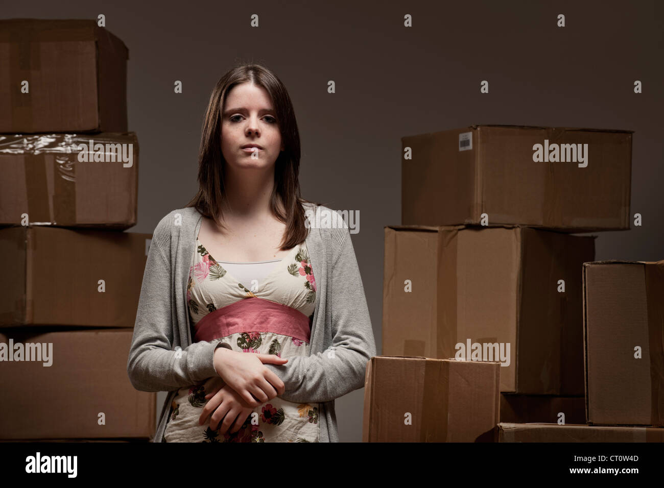 Teenage girl in pile of cardboard boxes Stock Photo - Alamy