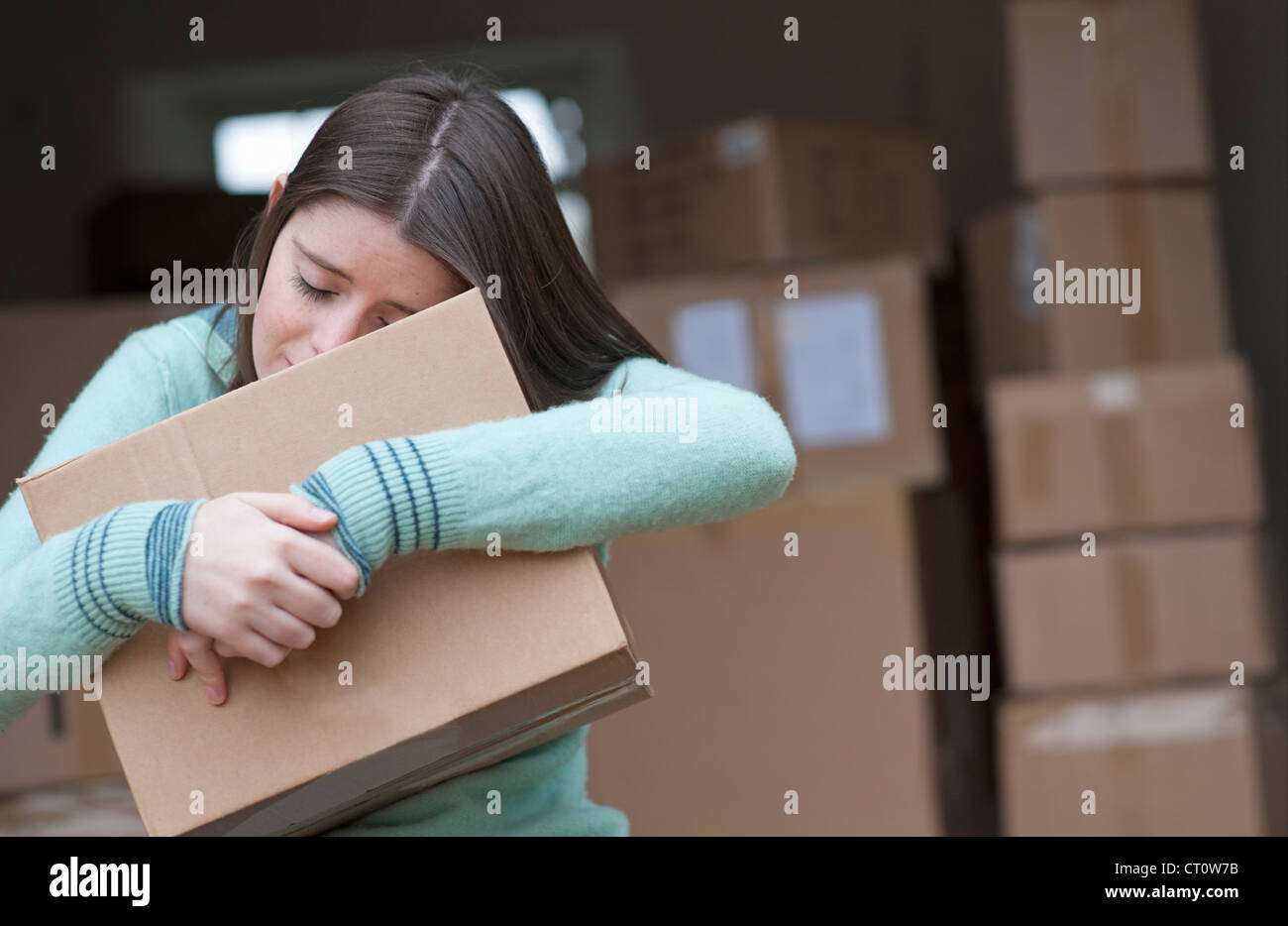 Teenage girl hugging cardboard box Stock Photo - Alamy