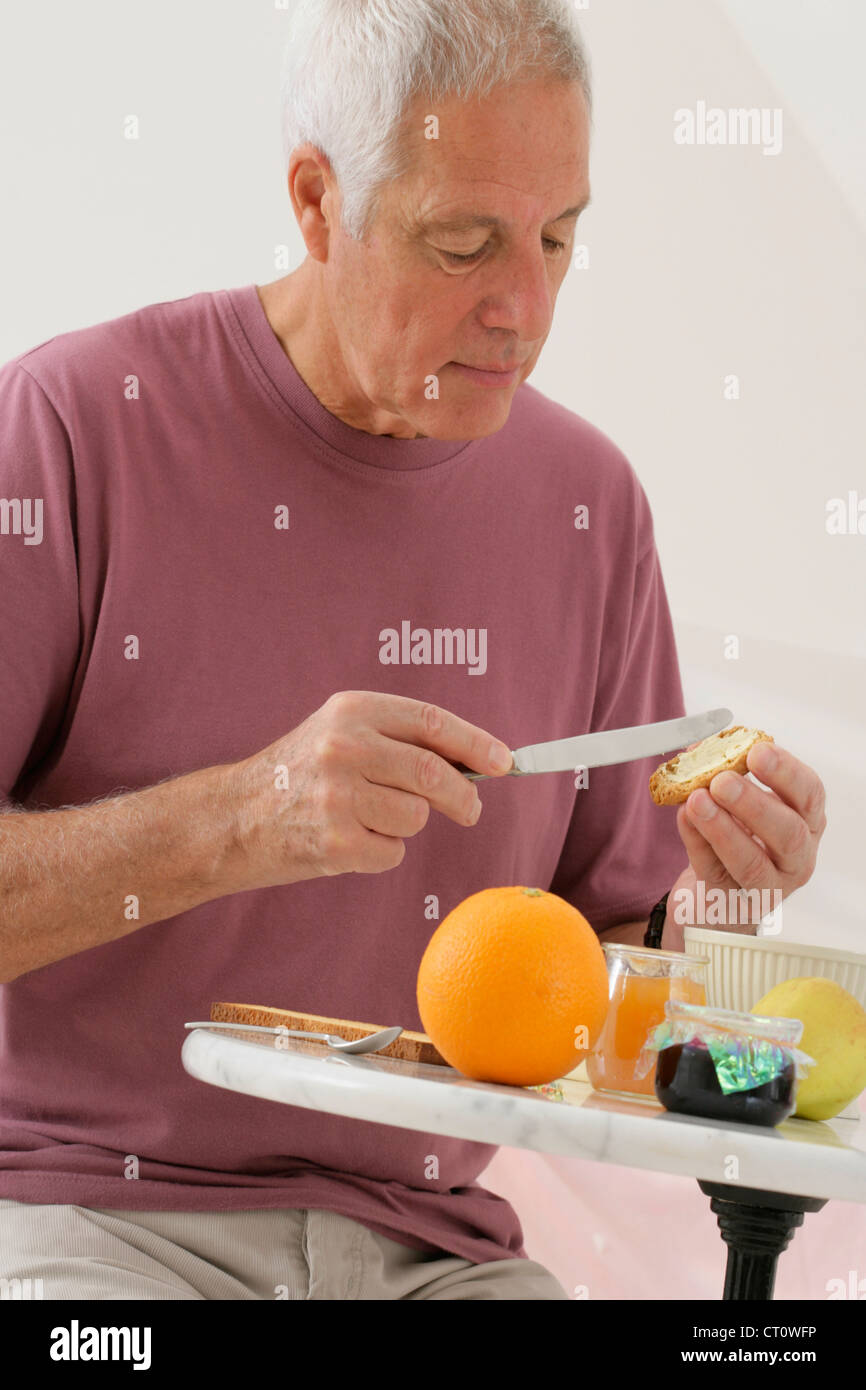 ELDERLY PERSON EATING BREAKFAST Stock Photo - Alamy