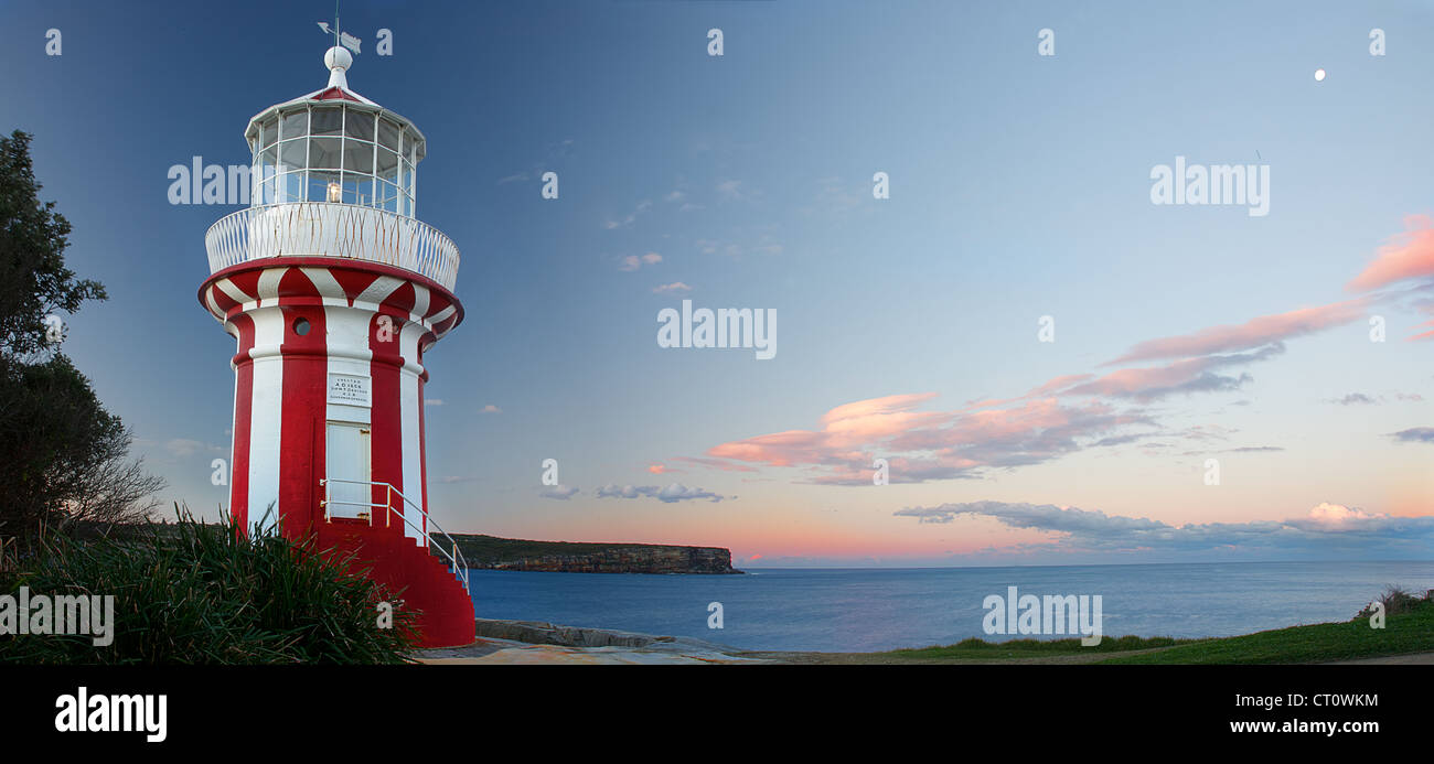 lighthouse at dusk overlooking water Stock Photo - Alamy