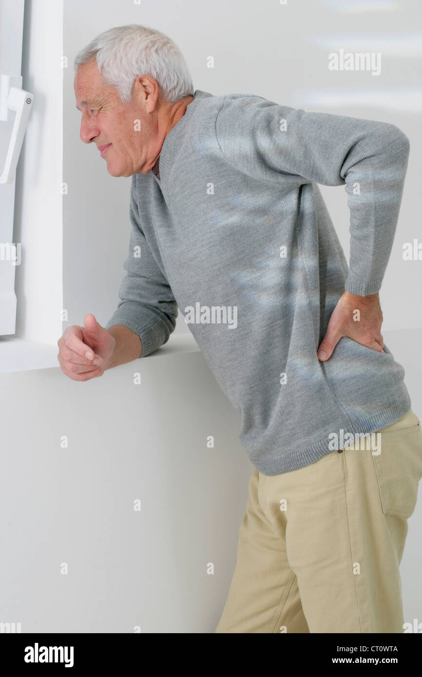 LOWER BACK PAIN IN ELDERLY PERS Stock Photo - Alamy