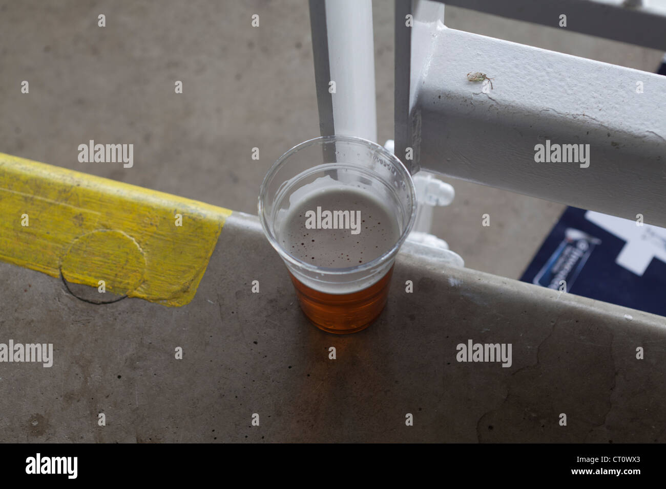 Half drunk beer in plastic cup at sporting event Stock Photo - Alamy