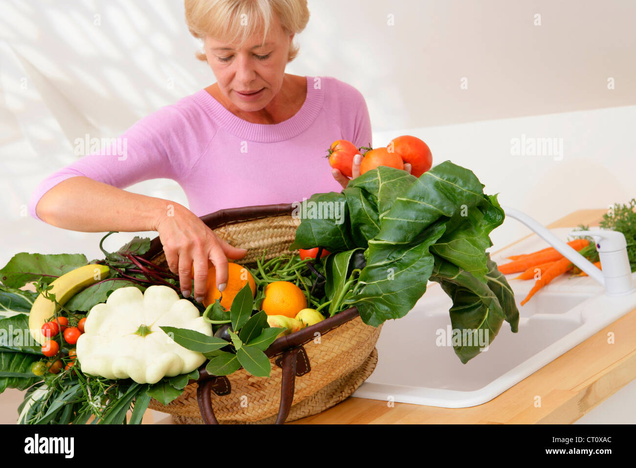 ELDERLY PERSON IN KITCHEN Stock Photo - Alamy