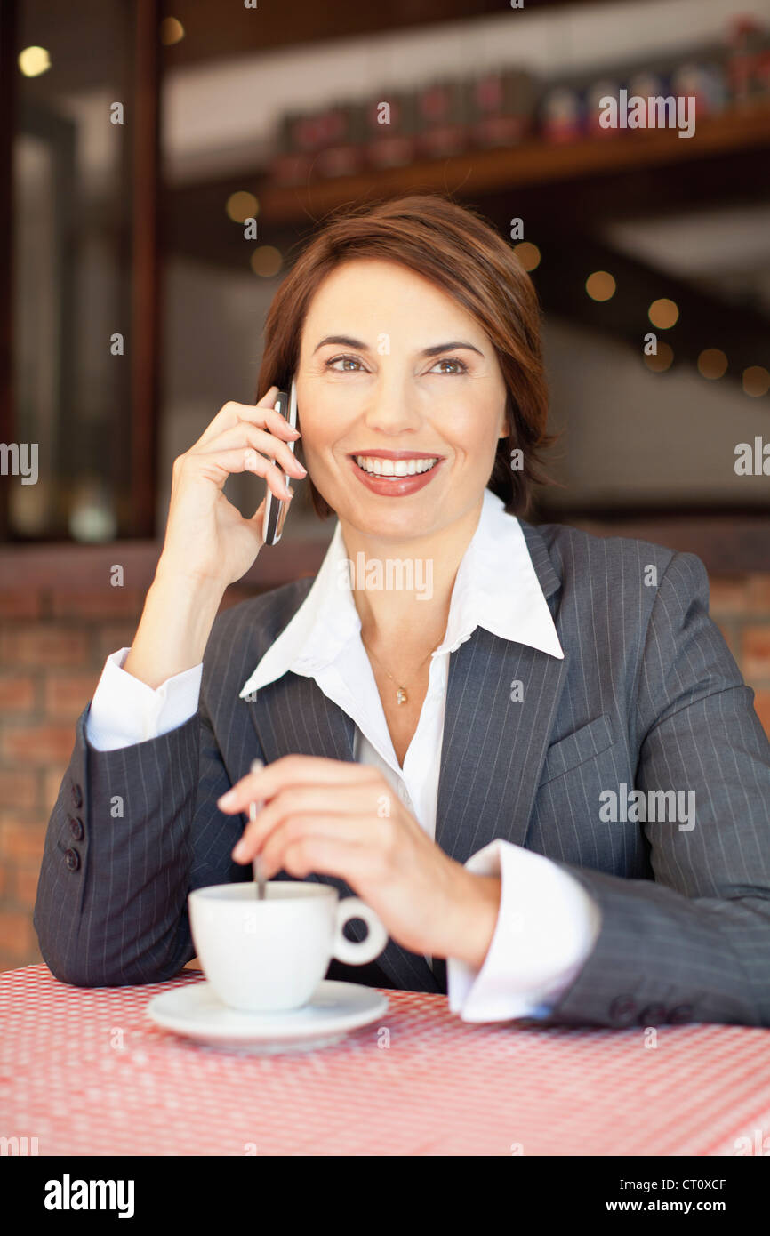 Businesswoman having coffee in cafe Stock Photo - Alamy