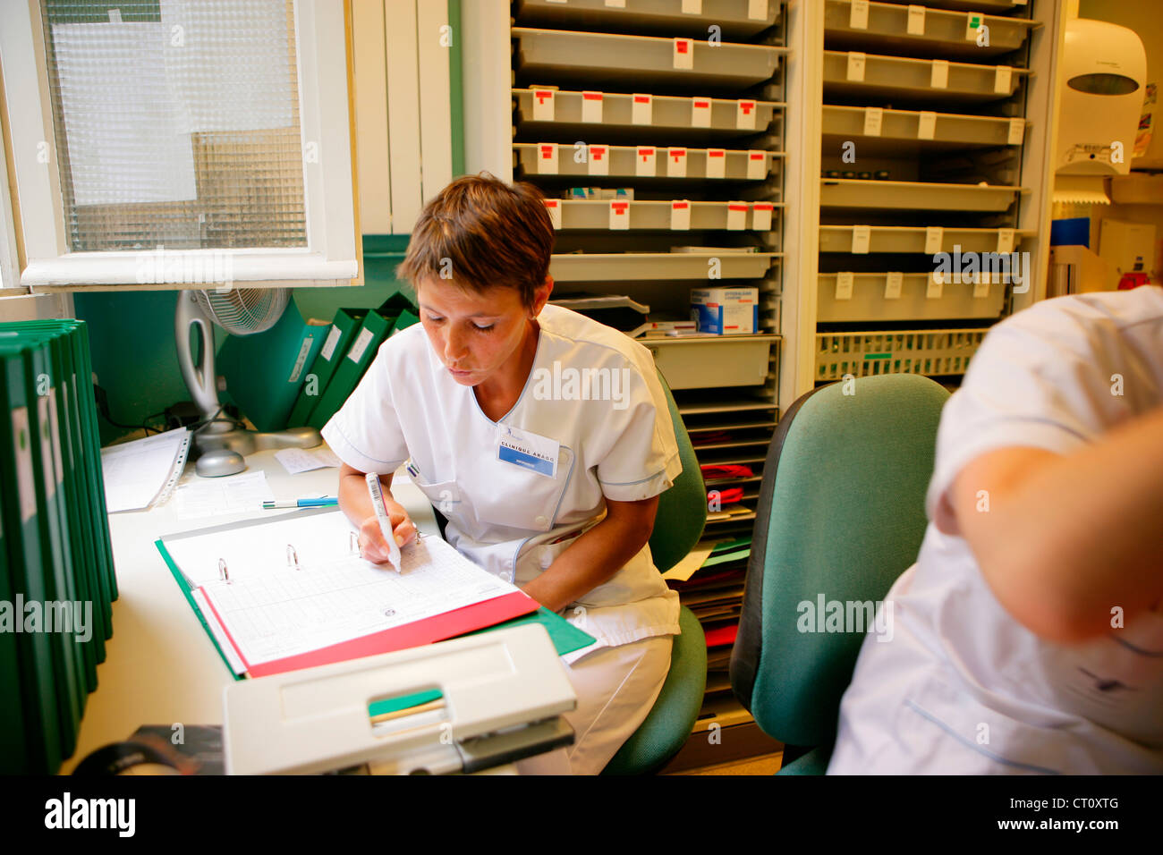 NURSE WITH PATIENT'S RECORD Stock Photo - Alamy