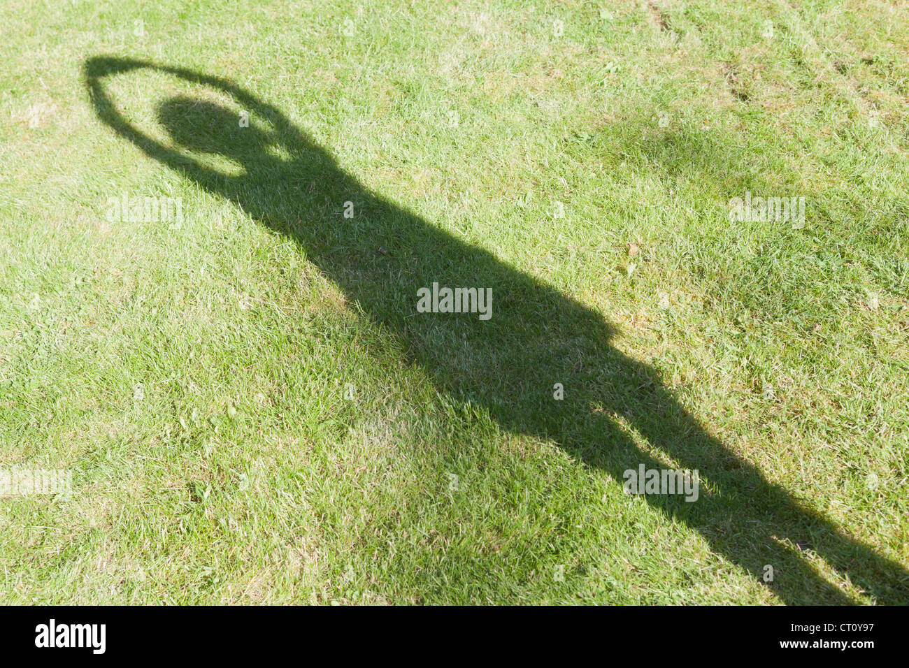 Shadow of girl on the grass Stock Photo - Alamy
