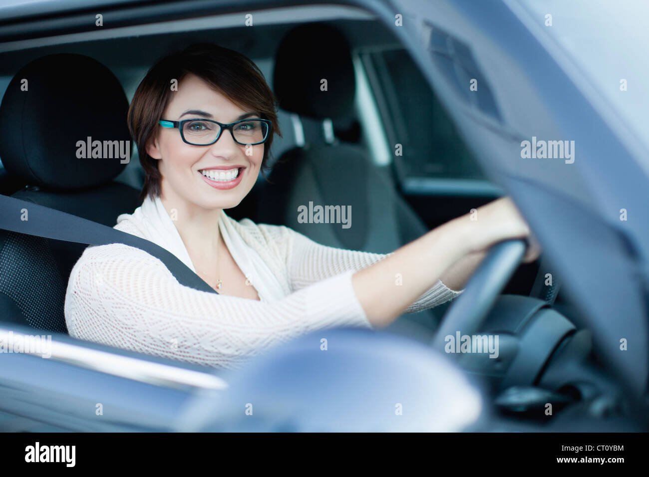 Smiling woman driving car Stock Photo - Alamy