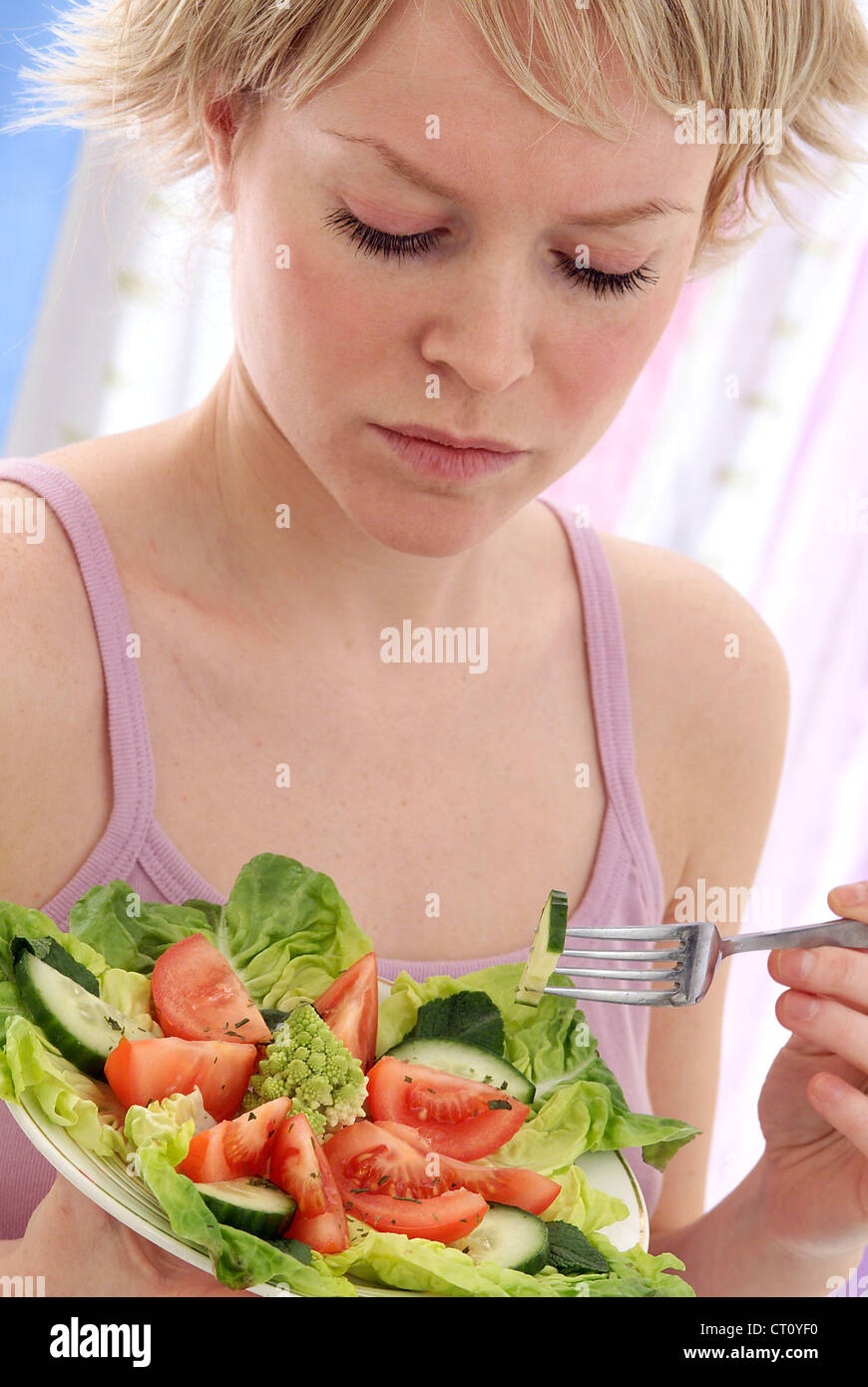 WOMAN EATING RAW VEGETABLES Stock Photo - Alamy