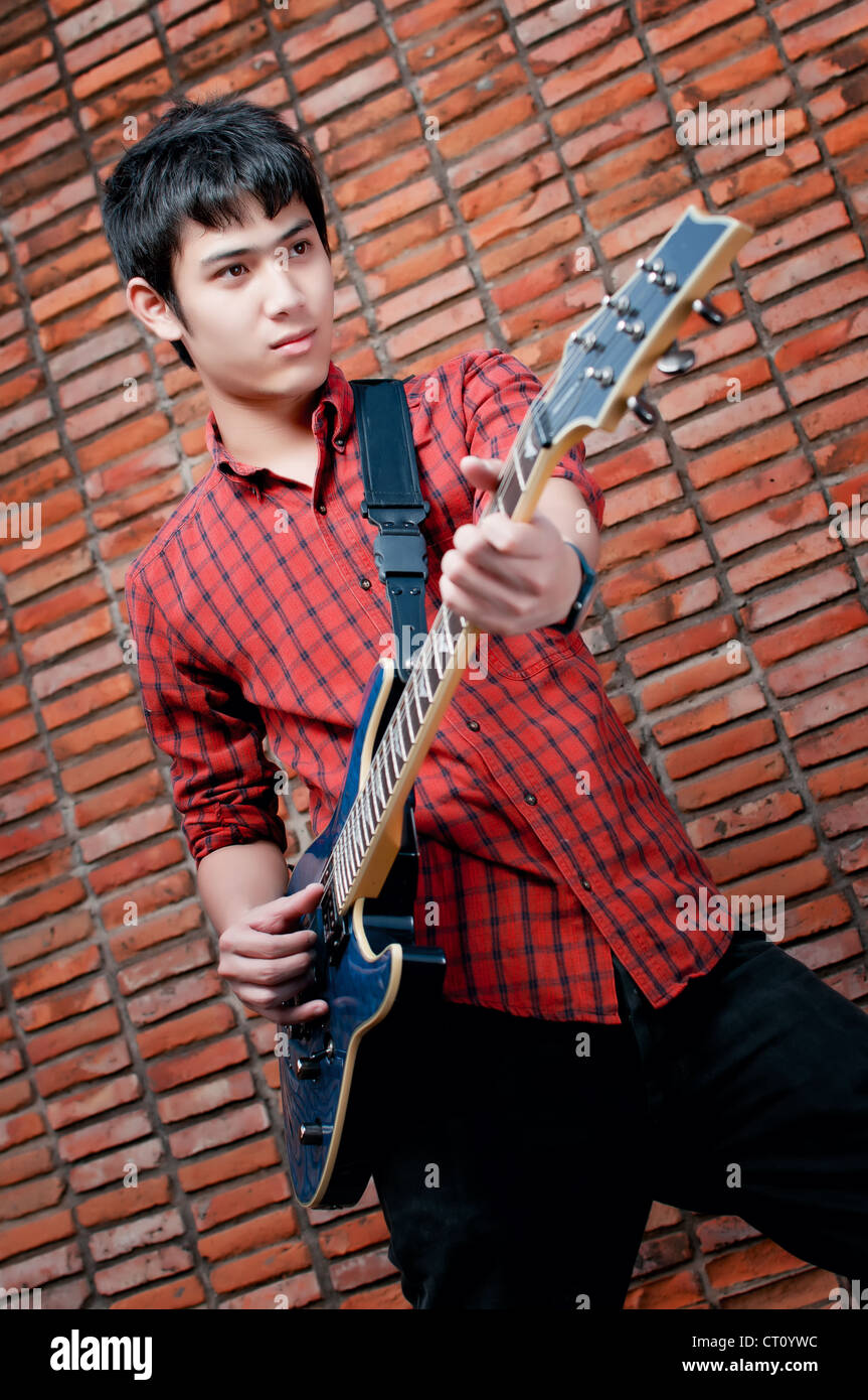 Handsome young musician playing the guitar and singing Stock Photo - Alamy
