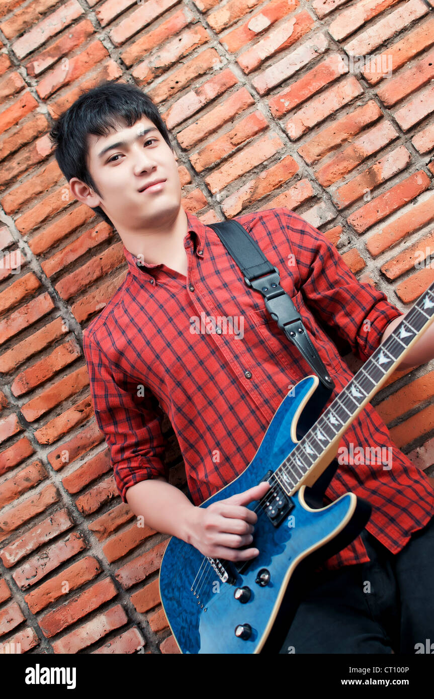 Handsome young musician playing the guitar and singing Stock Photo - Alamy