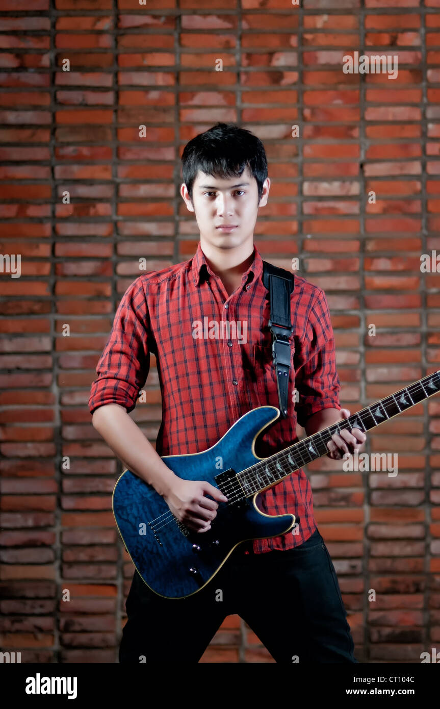 Handsome young musician playing the guitar and singing Stock Photo - Alamy