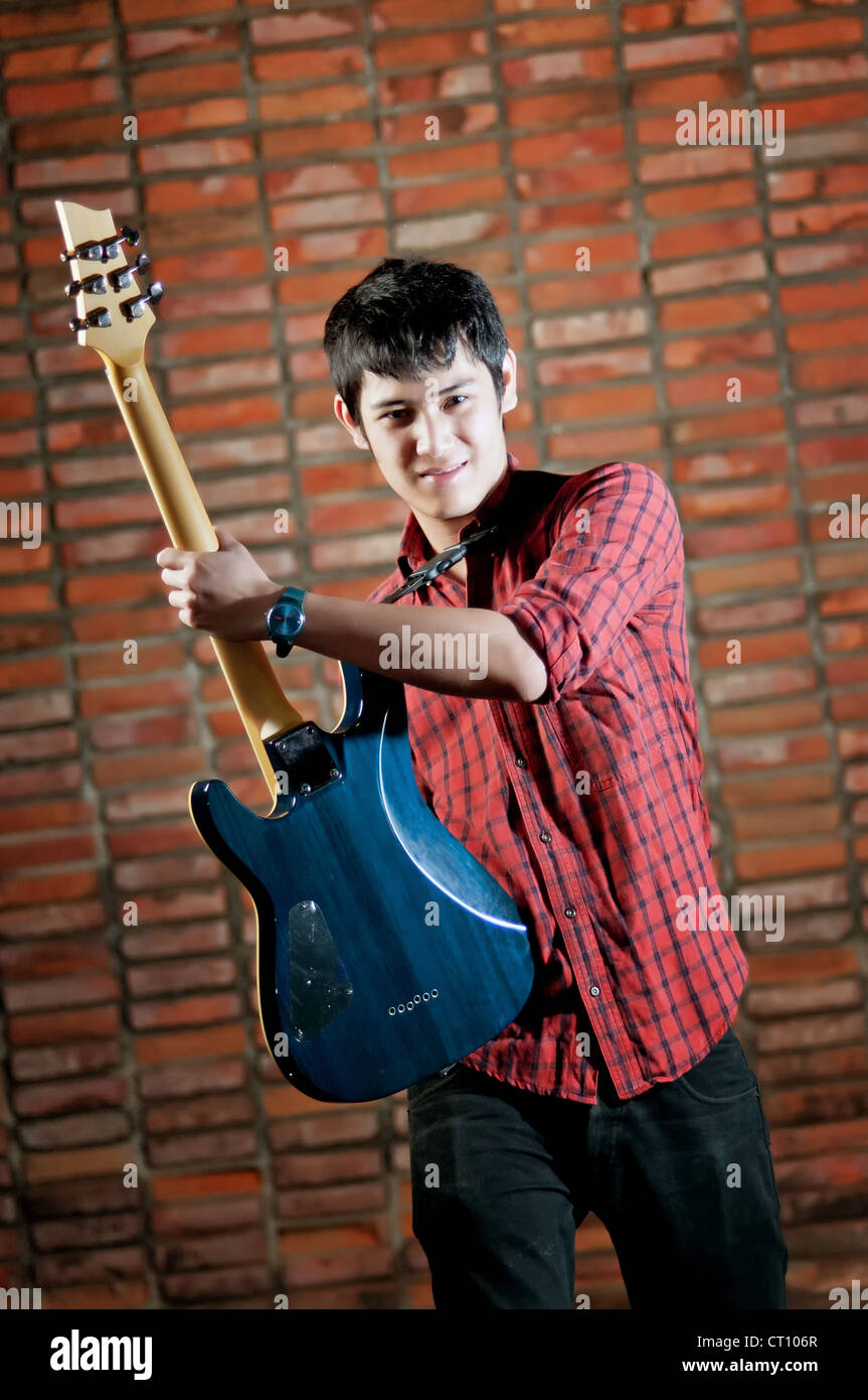 Handsome young musician playing the guitar and singing Stock Photo - Alamy