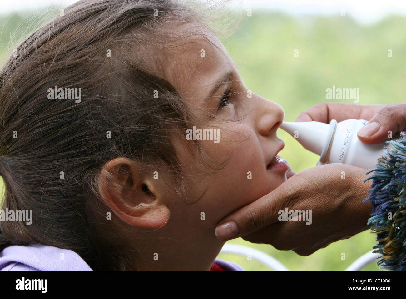 CHILD USING NOSE SPRAY Stock Photo - Alamy