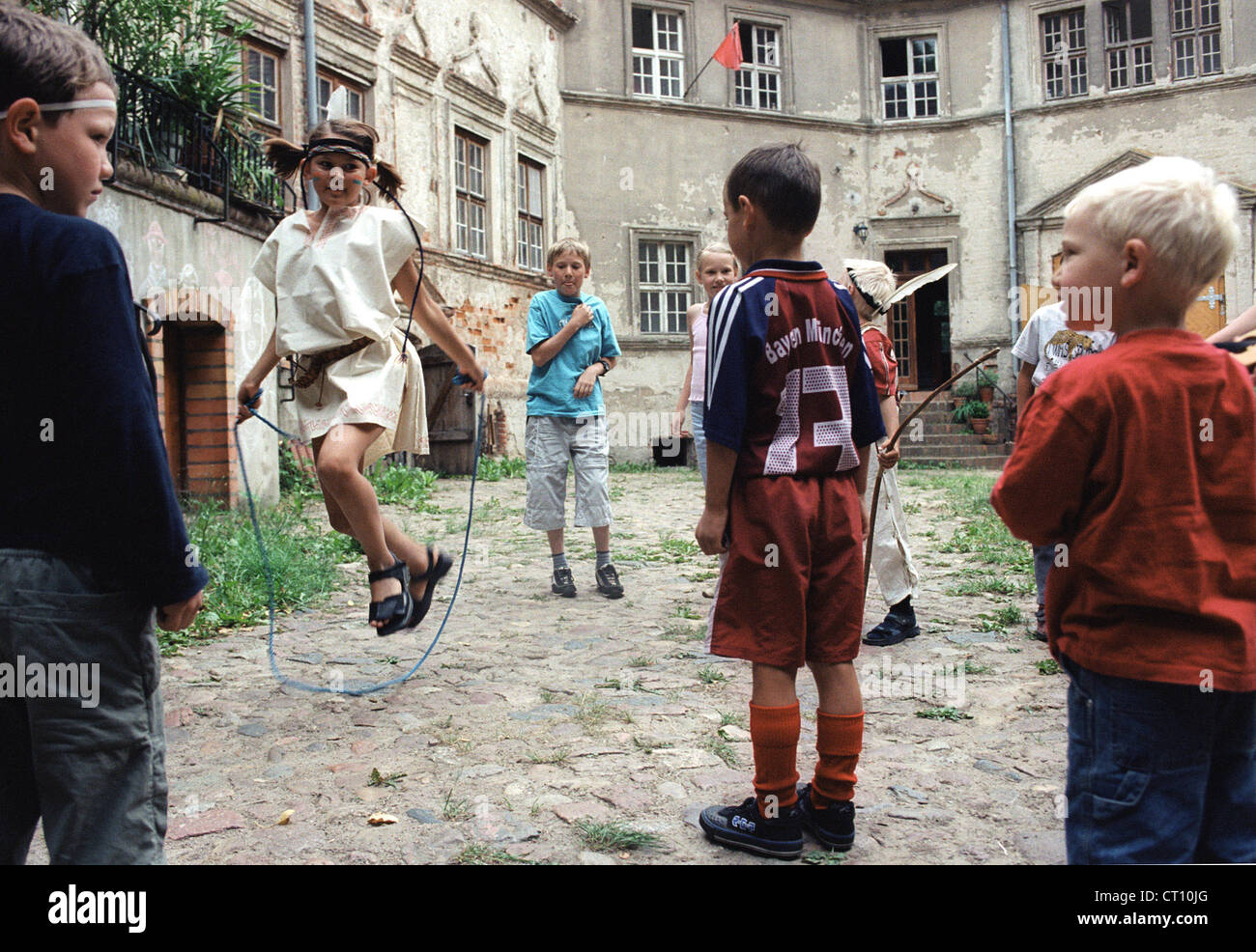 Children playing with a skipping rope Stock Photo - Alamy