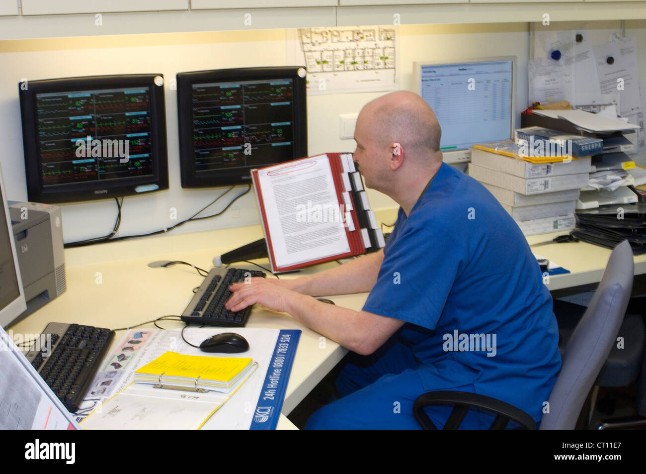 A doctor checks on a monitor the results of an endoscopic procedure ...