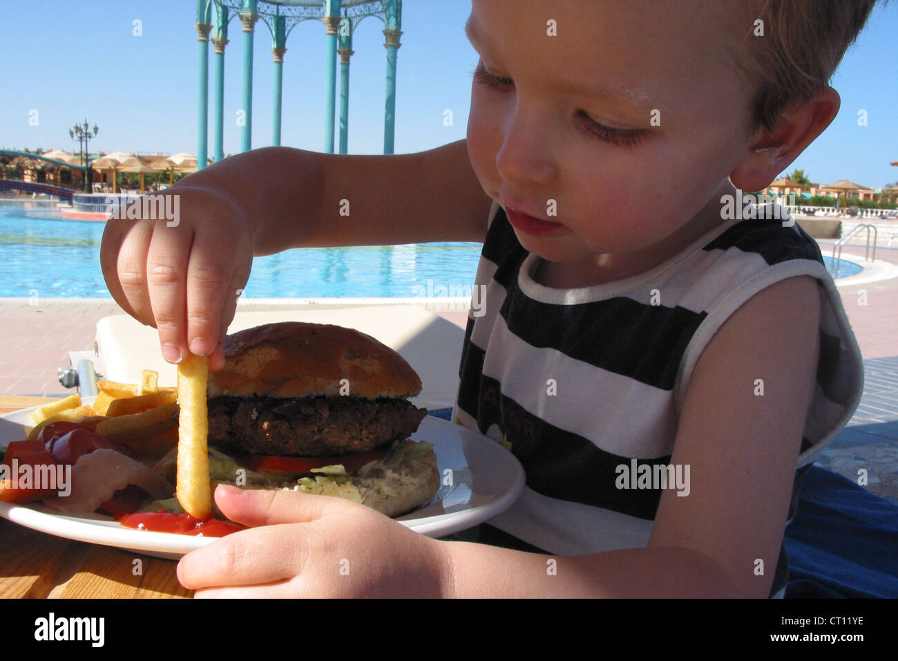 CHILD EATING MEAT Stock Photo - Alamy