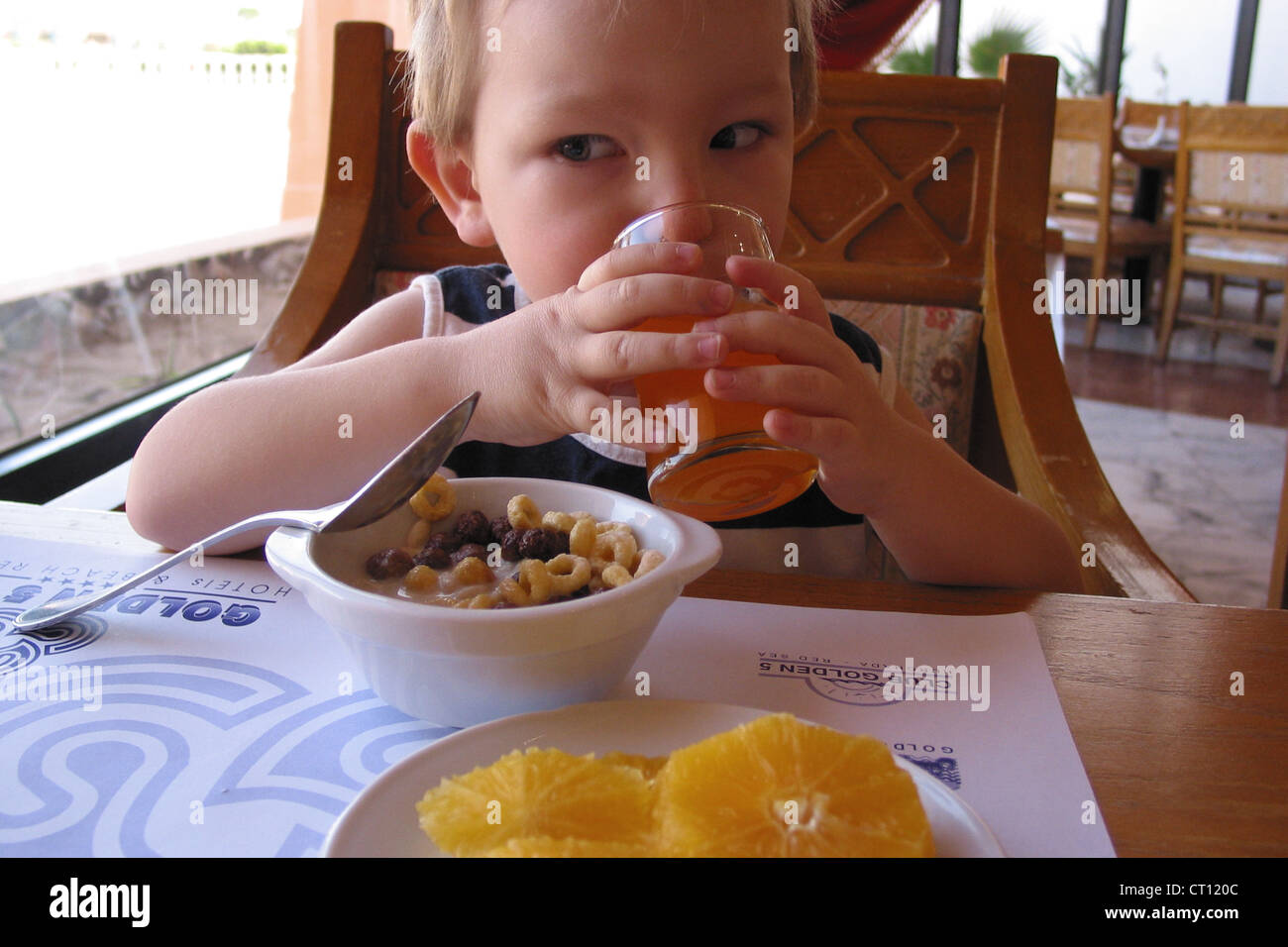 CHILD EATING BREAKFAST Stock Photo - Alamy