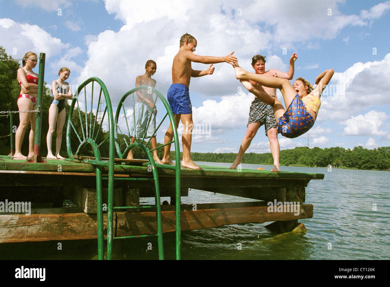 Boetzsee, teenagers throw a girl in the water Stock Photo - Alamy