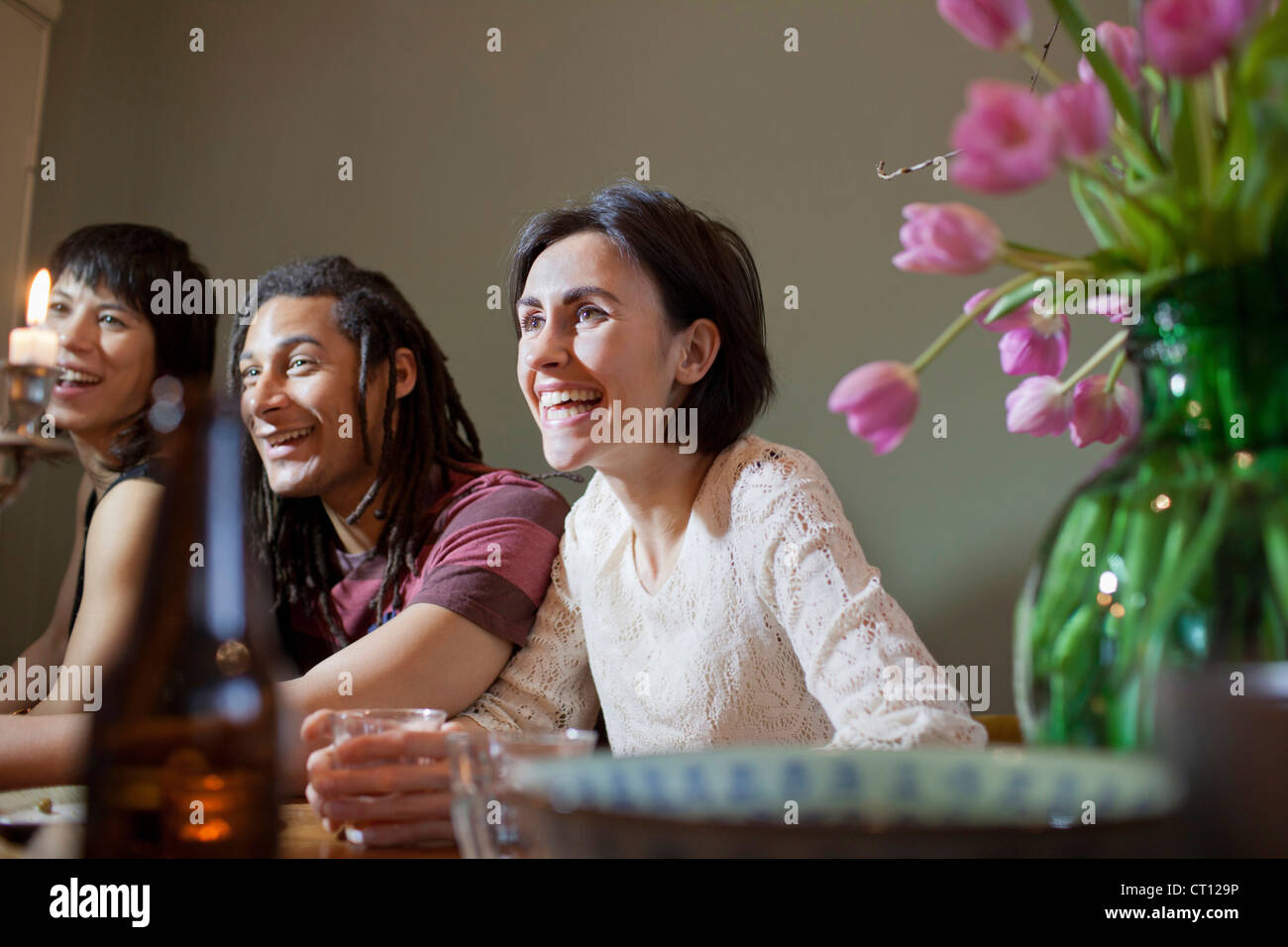 Friends talking at dinner table Stock Photo - Alamy