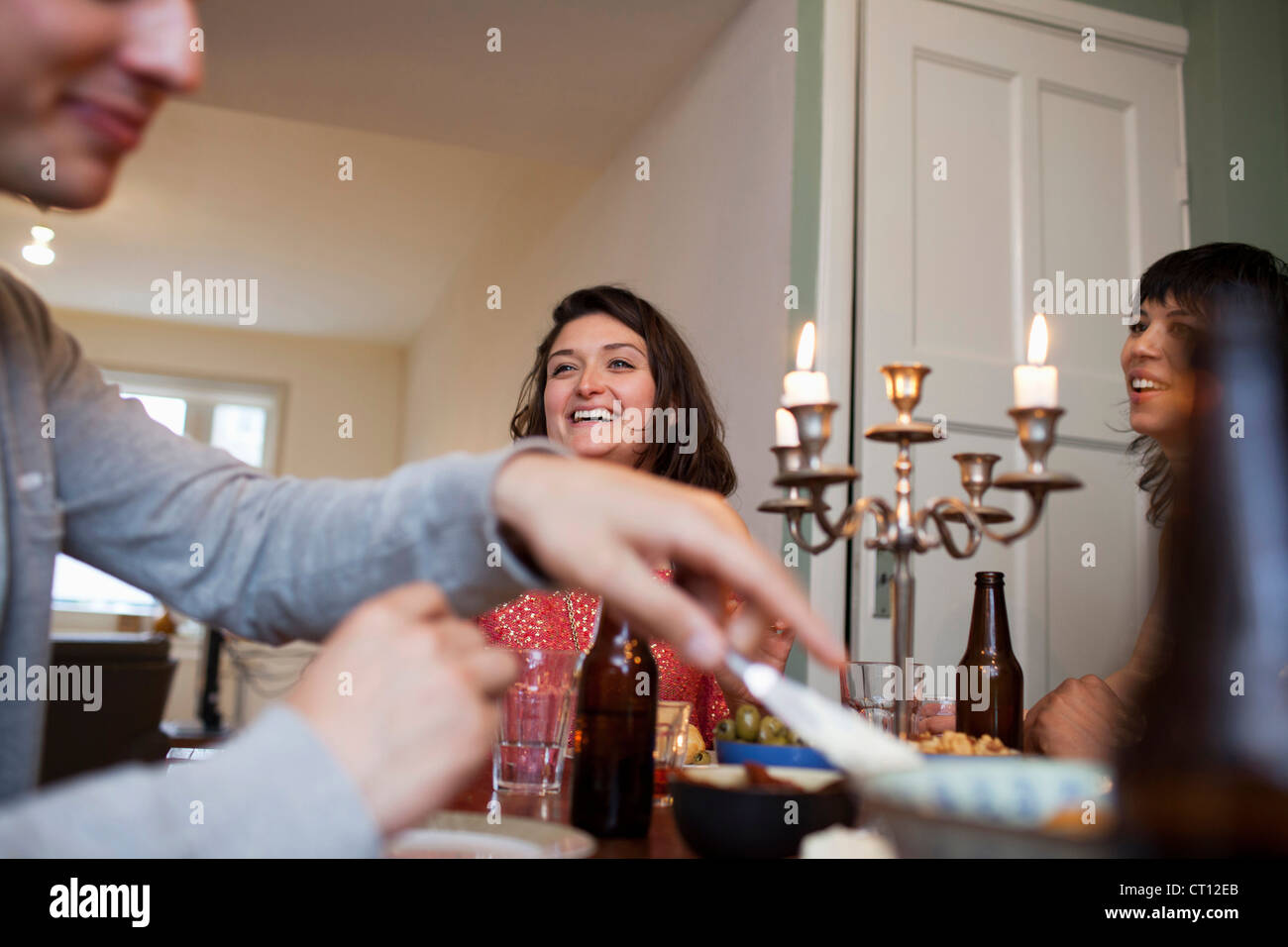Friends talking at dinner table Stock Photo - Alamy