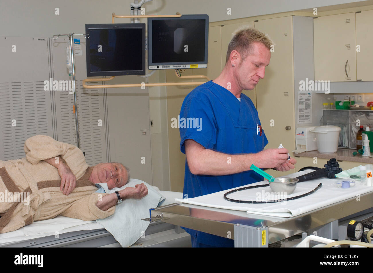 A doctor preparing a patient for an endoscopic procedure Stock Photo ...