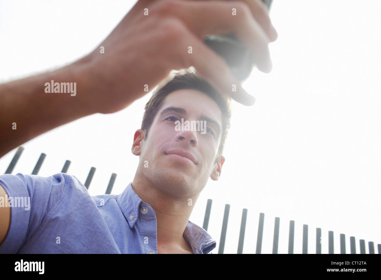 Man using cell phone on city street Stock Photo - Alamy