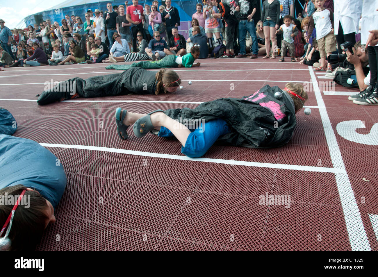 London Pleasure Gardens. Silly Olympics . Children doing slug racing in ...