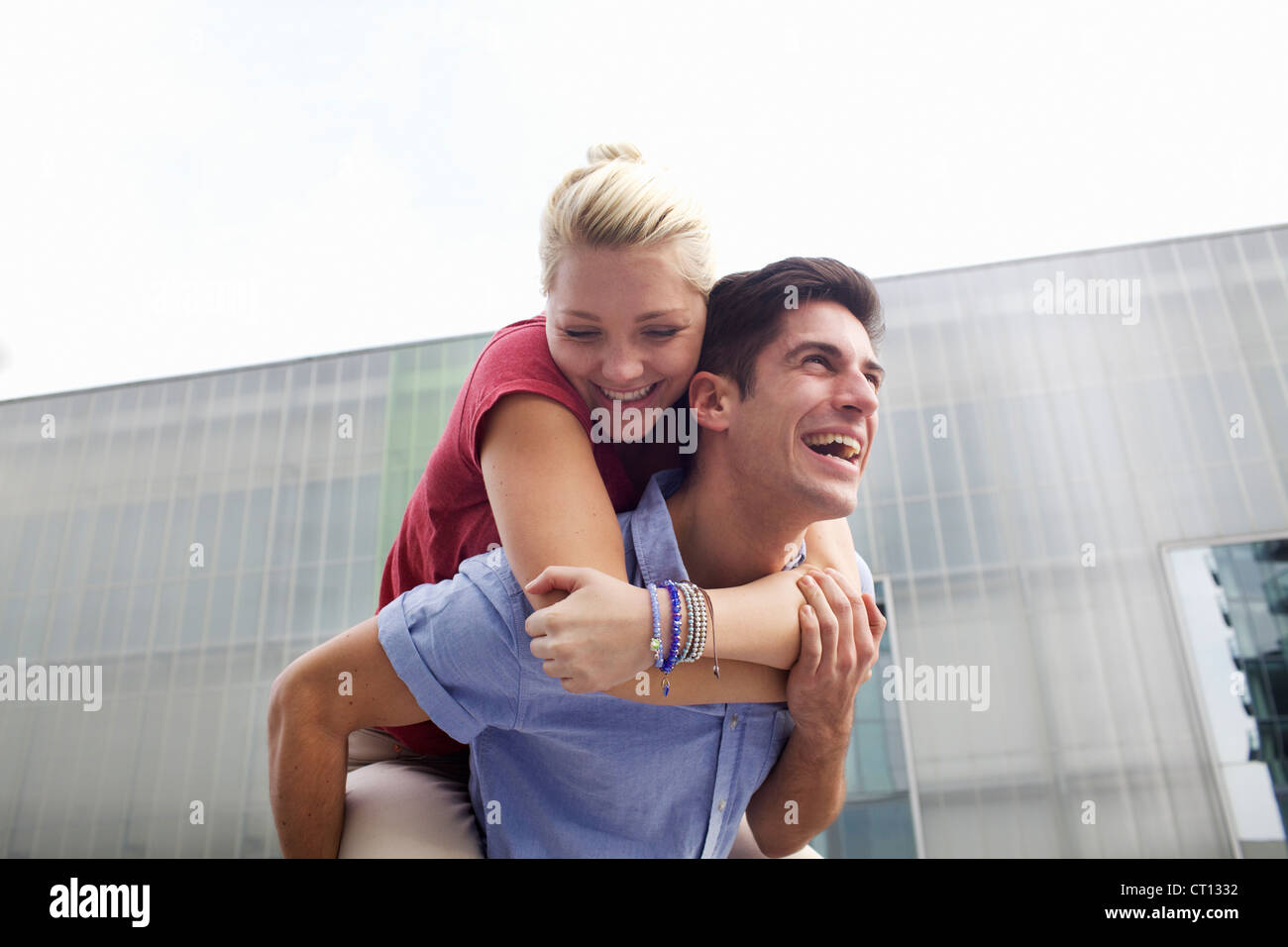 Man carrying girlfriend piggyback Stock Photo - Alamy