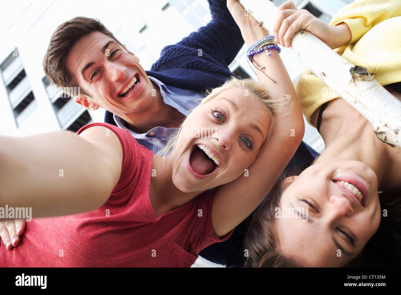 Friends playing together on city street Stock Photo - Alamy