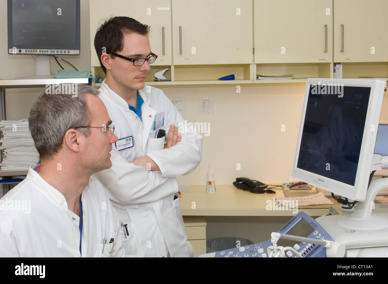 Two doctors review the results of an endoscopic examination on a ...