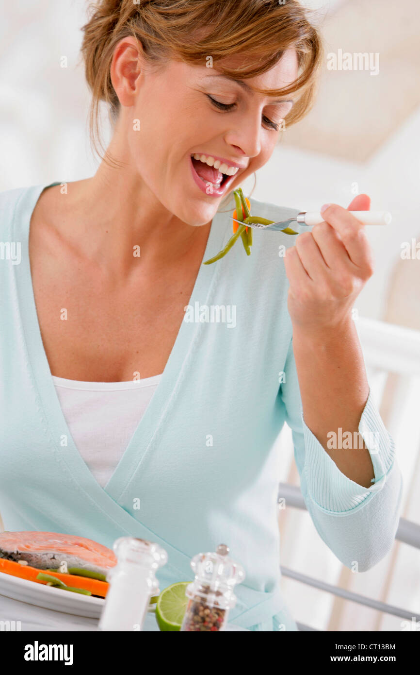 WOMAN EATING FISH Stock Photo - Alamy