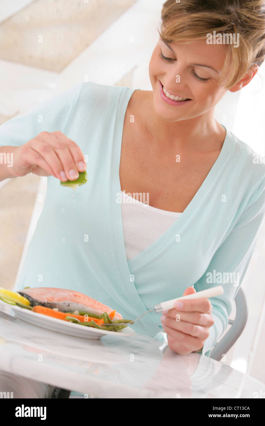 WOMAN EATING FISH Stock Photo - Alamy