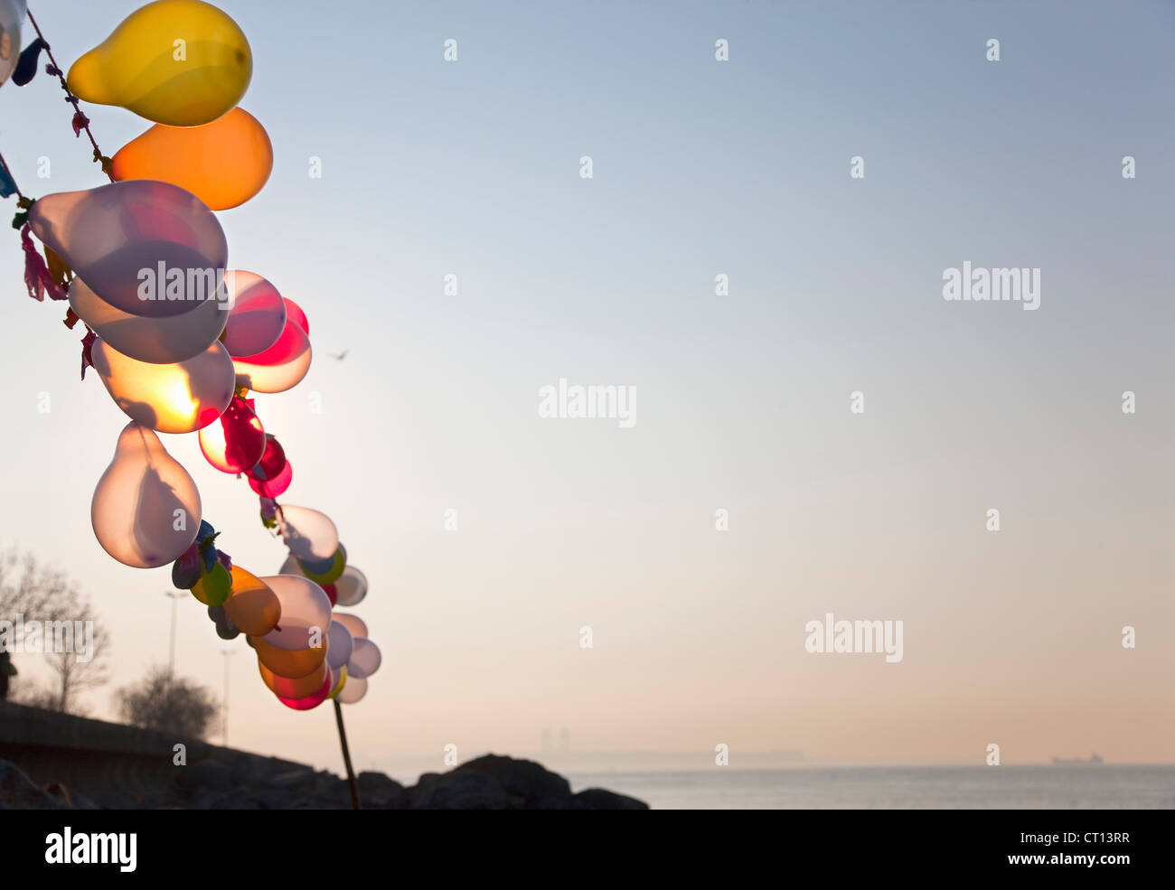 String of balloons floating in wind Stock Photo - Alamy